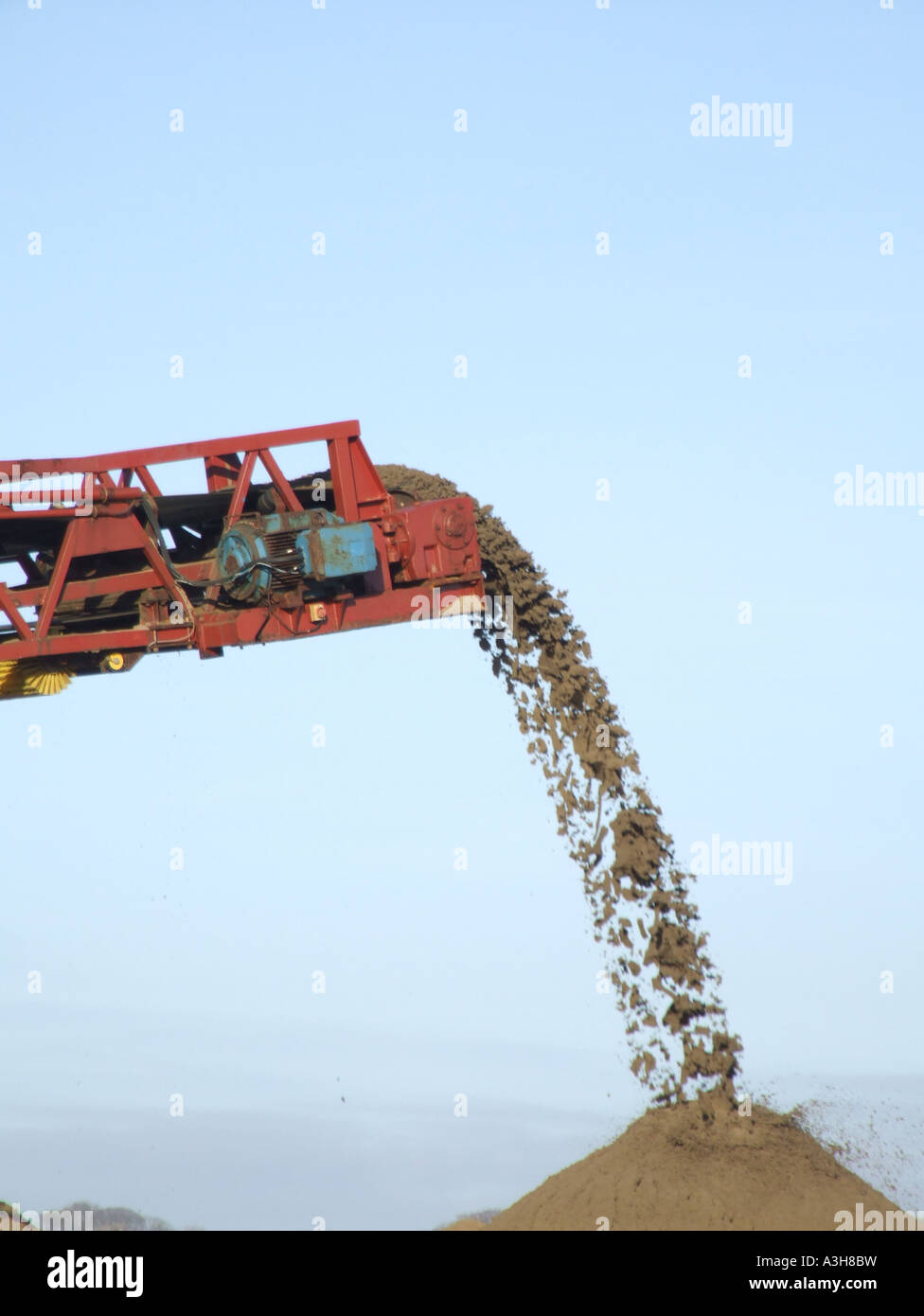 sand being transferred from ship trawler to builders yard Stock Photo ...