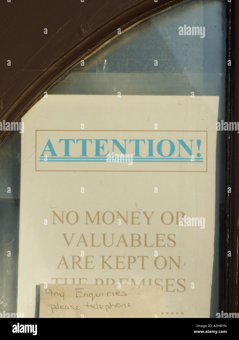 no money or valuables are kept on premises message in shop window Stock ...
