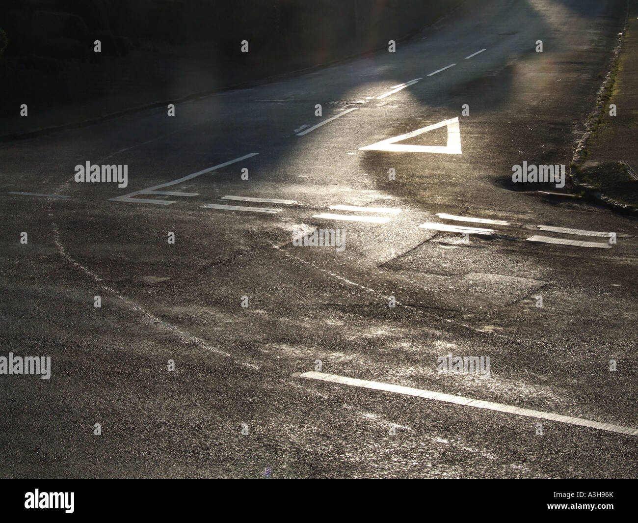 junction turning on empty road in sun Stock Photo - Alamy