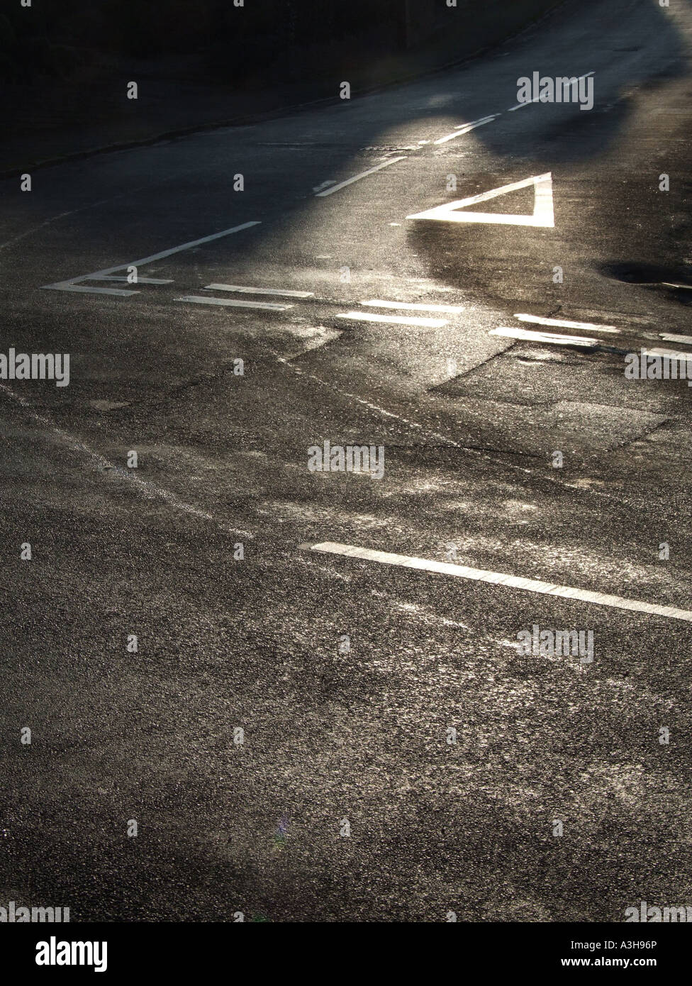 junction turning on empty road in sun Stock Photo - Alamy