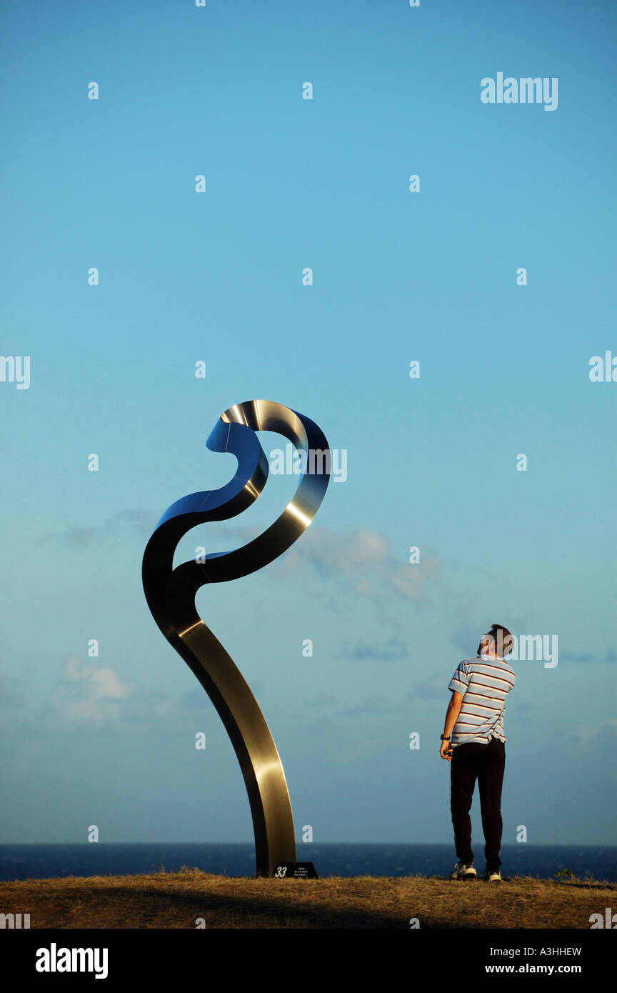 Man looking at sculpture Stock Photo - Alamy