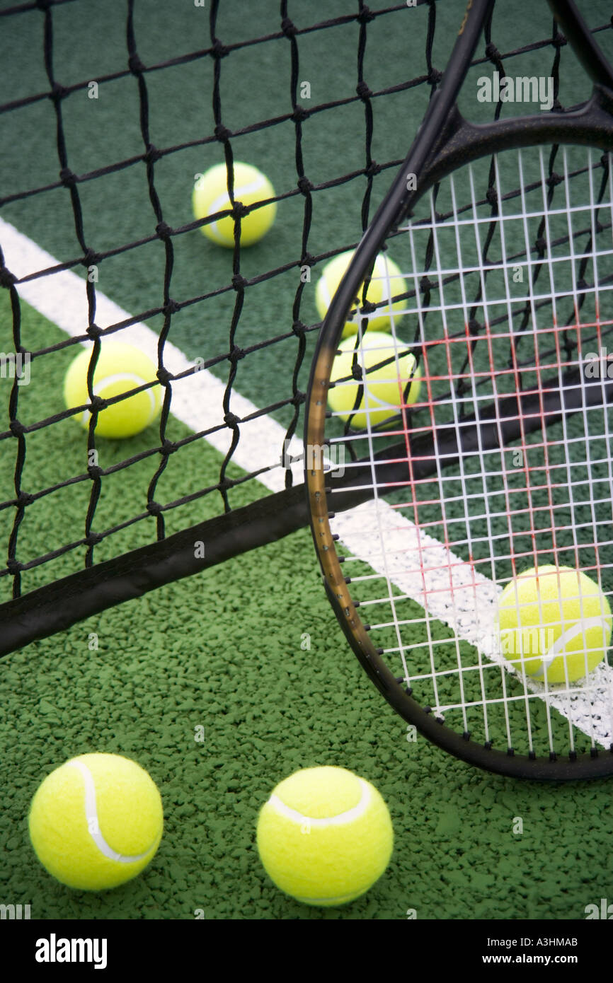 Tennis balls and racket on tennis court Stock Photo - Alamy