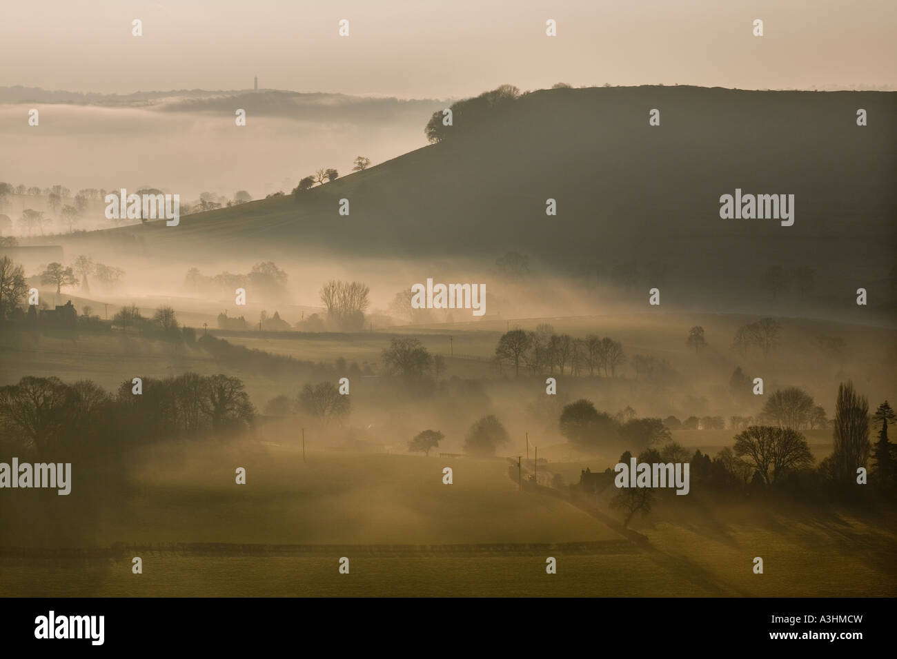 Cam Long Down shrouded in mist from Coaley Peak on the Cotswold Way ...