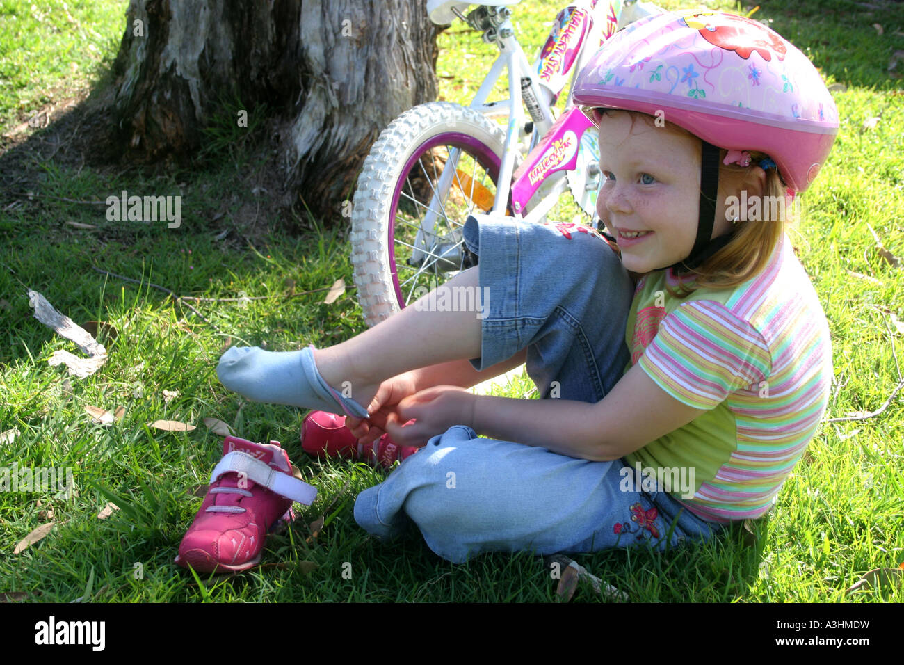 Ade 491 Child pulling un socks Stock Photo - Alamy