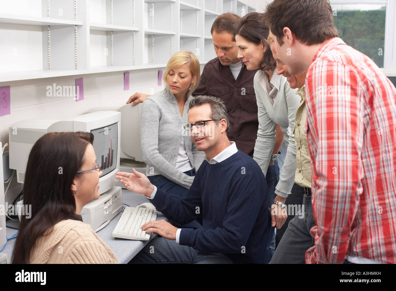 Students helping each other in class hi-res stock photography and ...