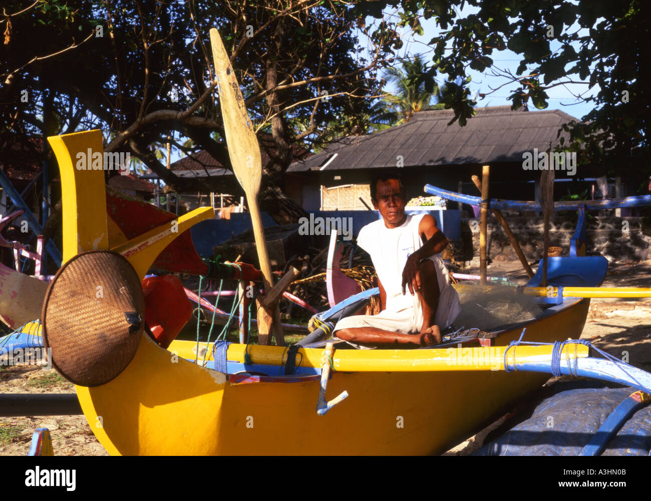 traditional conical straw hat on the prow of a traditional fishing boat ...