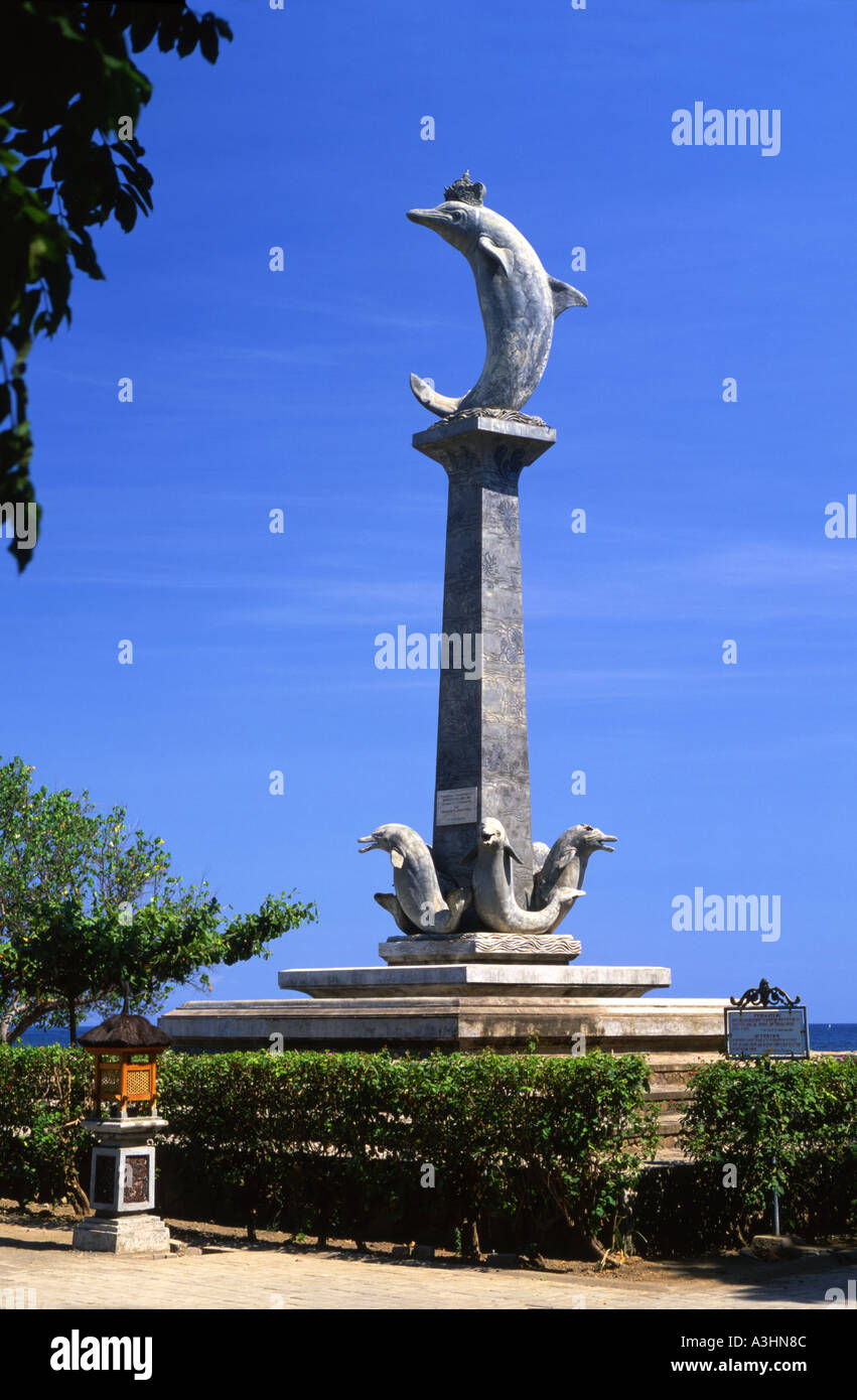 Large stone column with a statue of a dolphin on the top at Lovina Bali ...