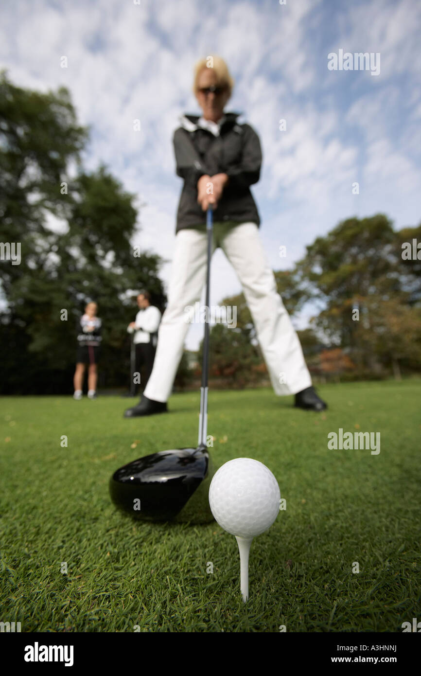 Blonde woman swinging golf club hi-res stock photography and images - Alamy