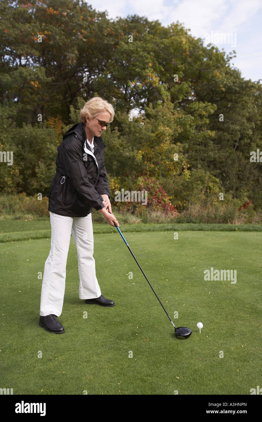 Blonde woman swinging golf club hi-res stock photography and images - Alamy