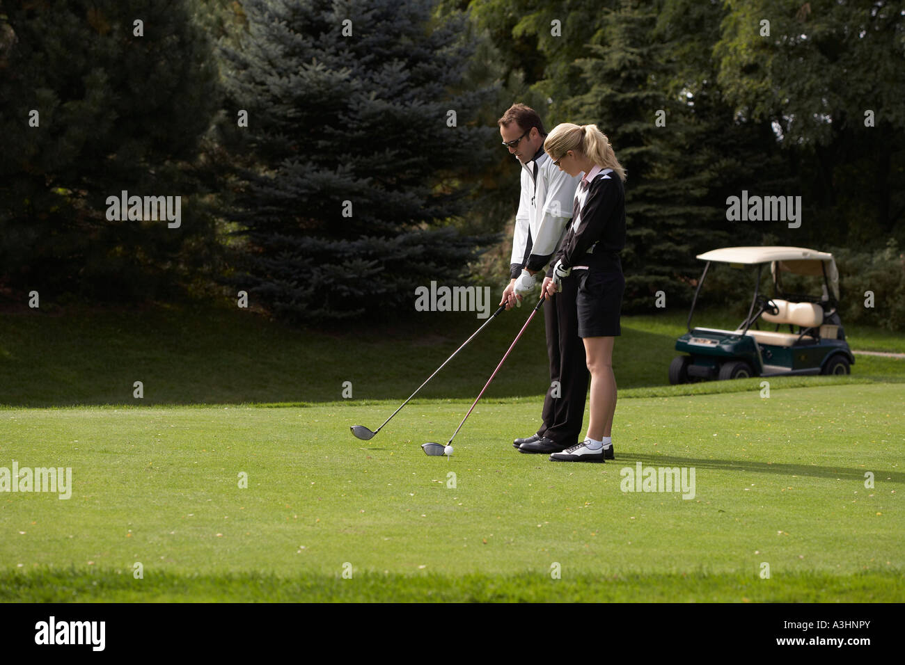 Man and Woman Golfing Stock Photo - Alamy