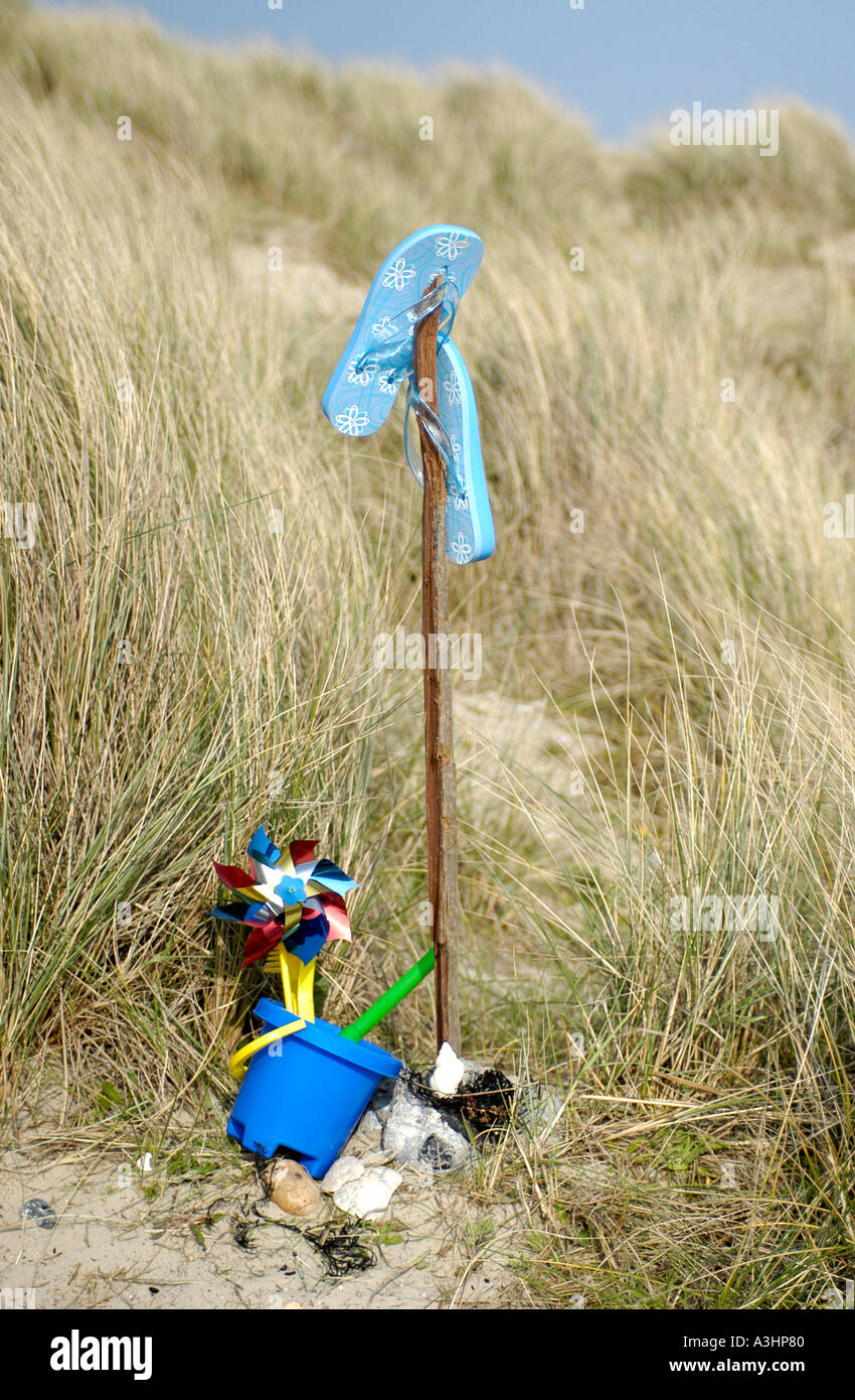 flip flops,bucket, spade and a windmill on a sandy beach Stock Photo ...