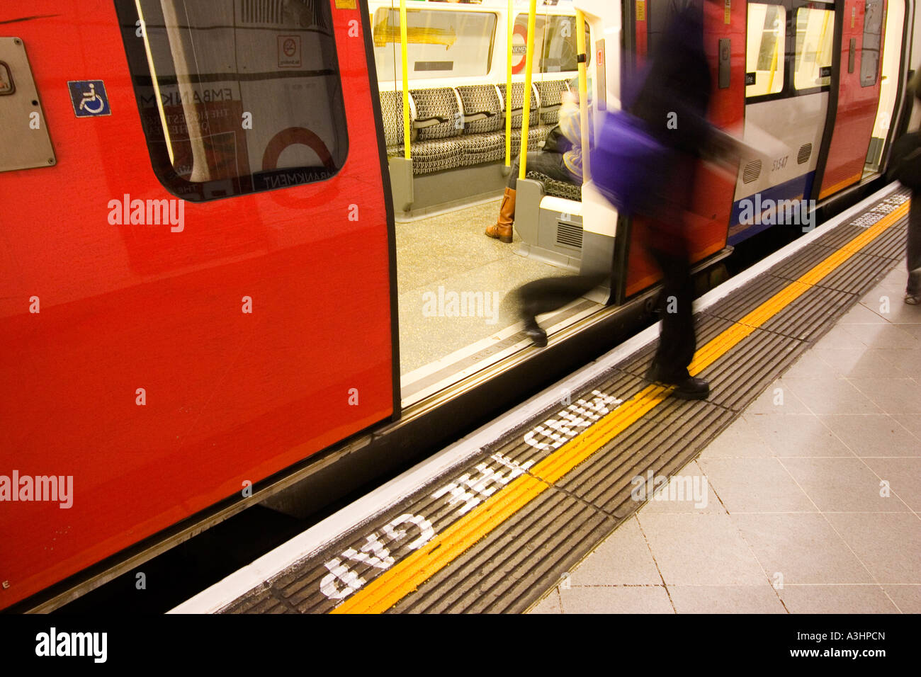 man stepping off London underground train Stock Photo - Alamy