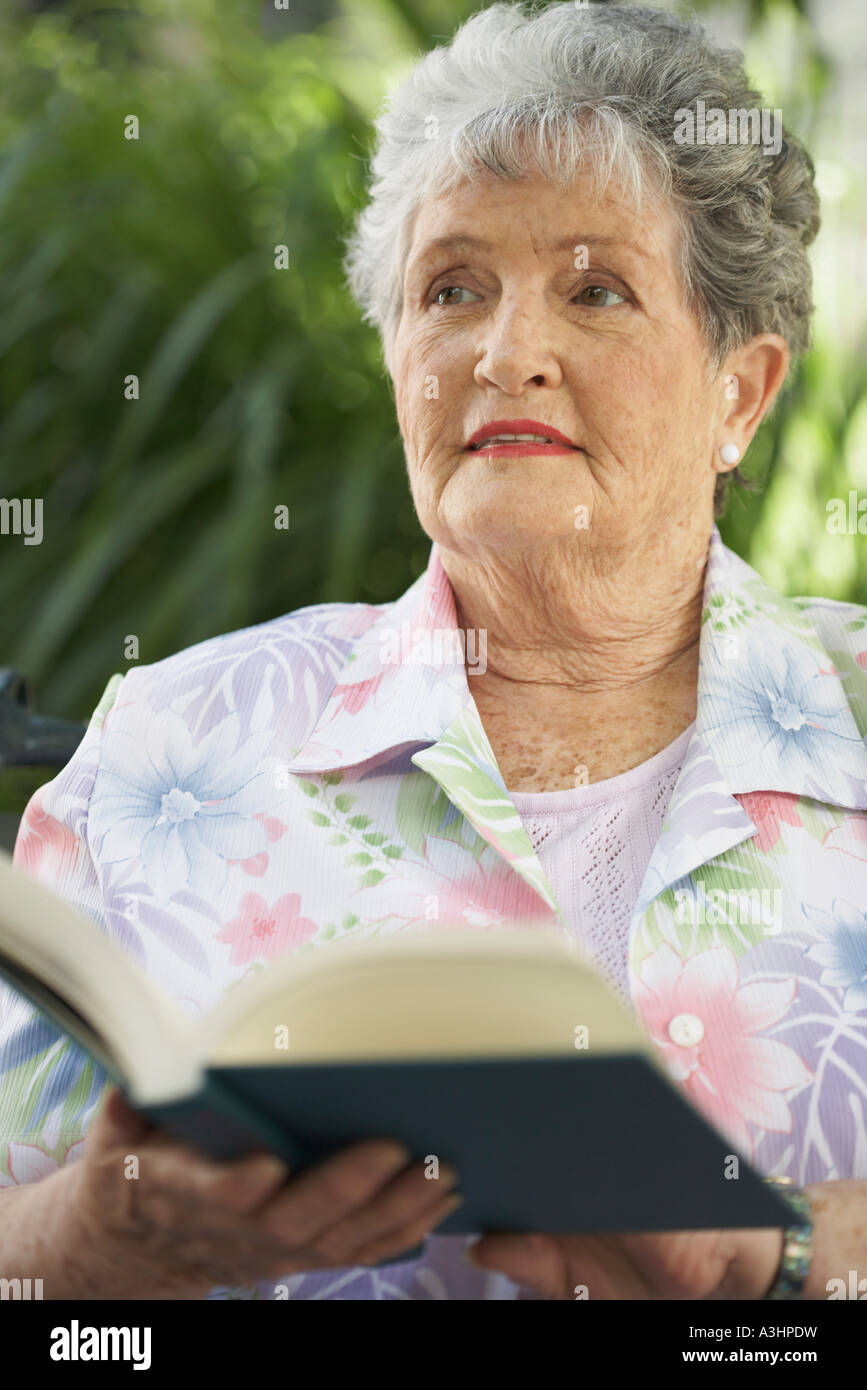 Old woman elderly sit sitting read reading book relax hi-res stock ...