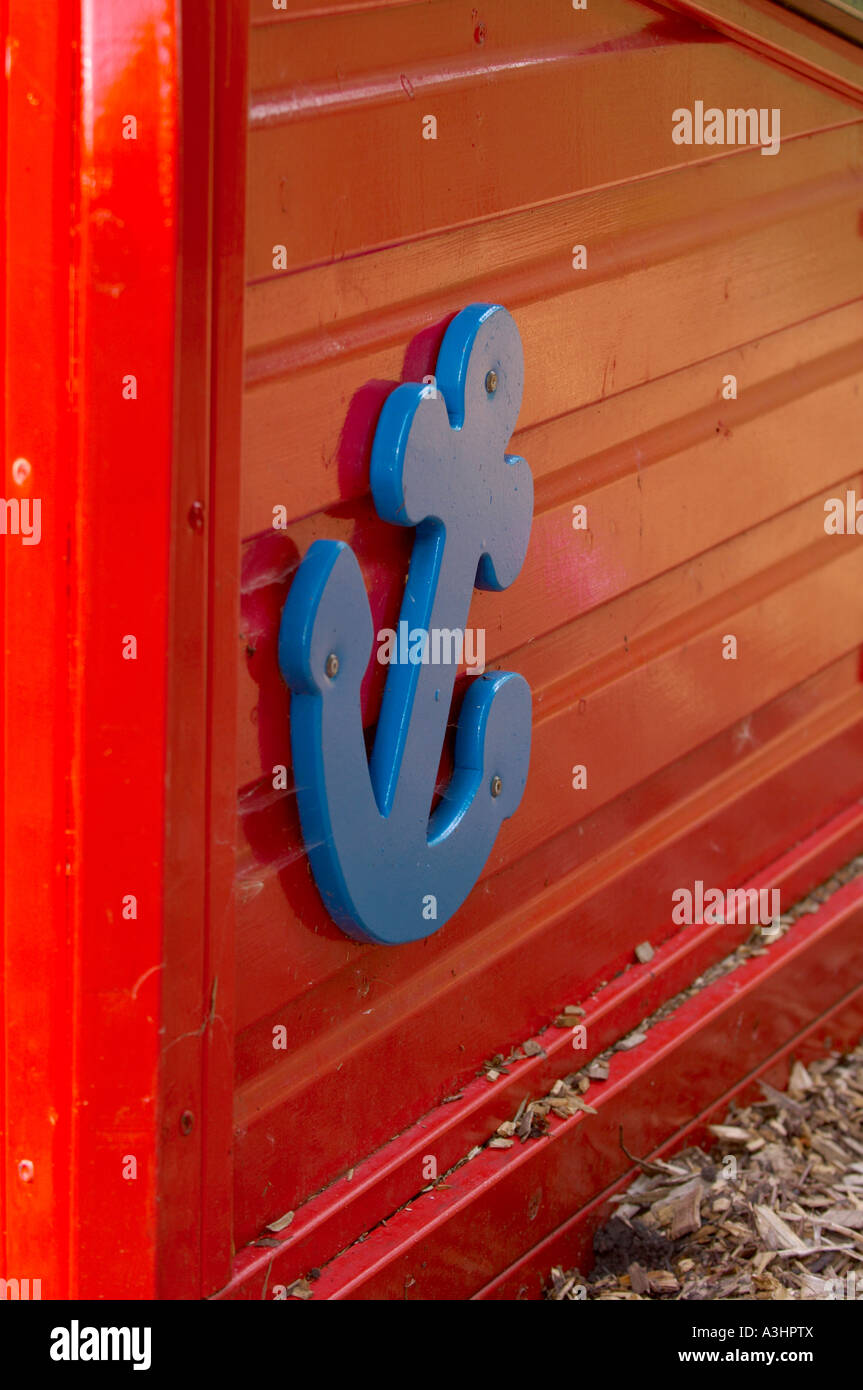 Blue-painted ships anchor and red play equipment in a children's ...