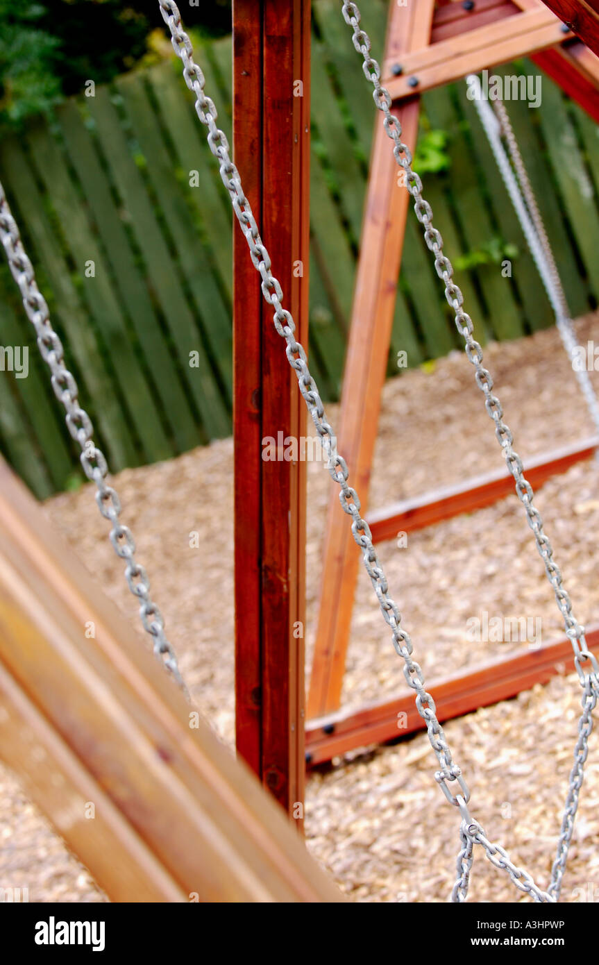 abstract vertical photo of swing chains and wooden play equipment in ...