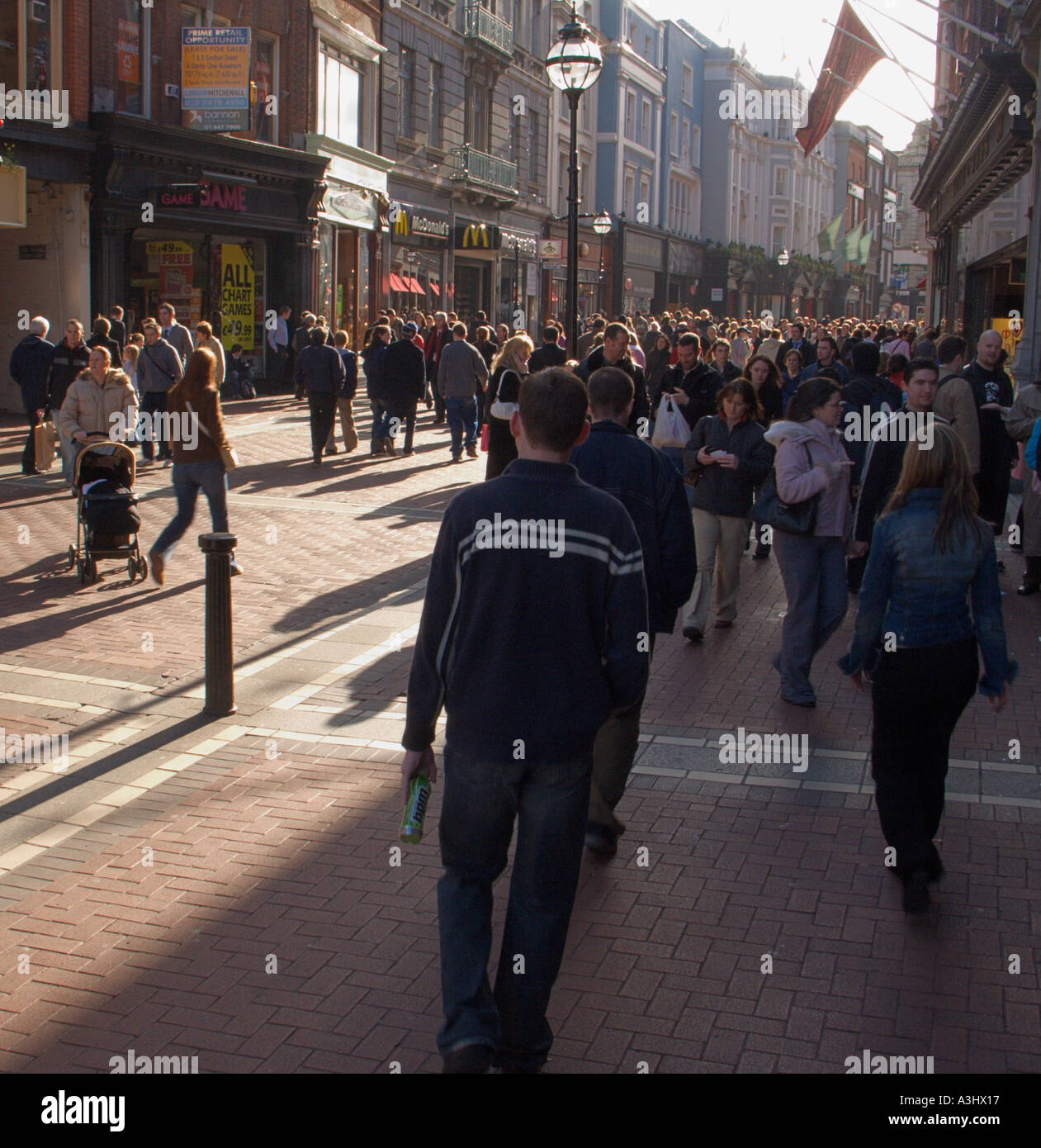 Busy crowded street scene, shopping in Graften Street, Dublin, Ireland ...