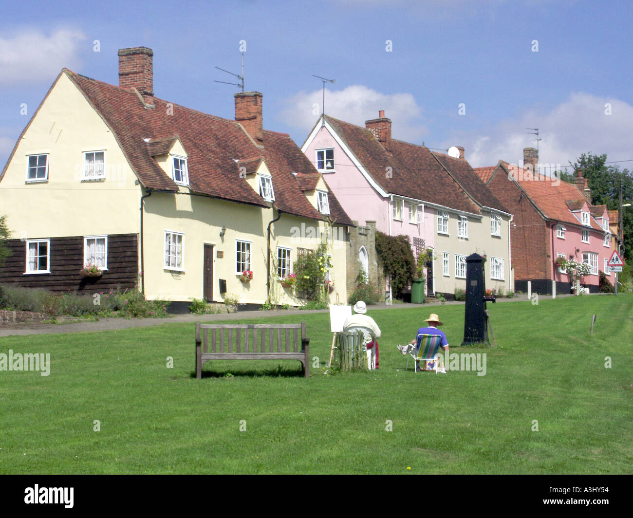 Monks Eleigh Suffolk village green with cottages people relaxing ...