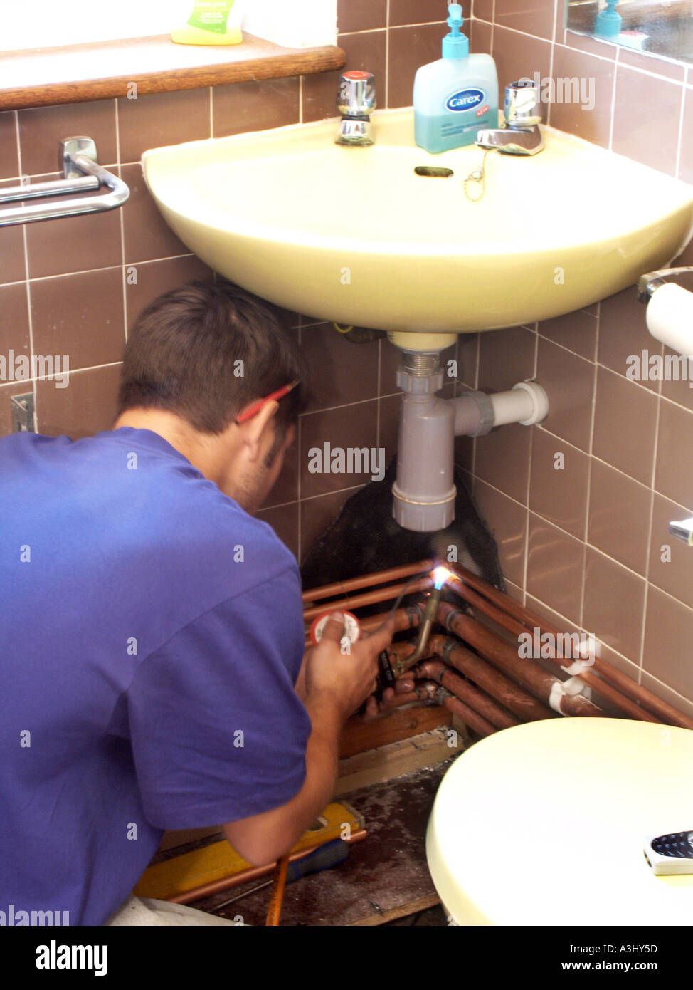 Back of supervised apprentice plumber work in residential property ...