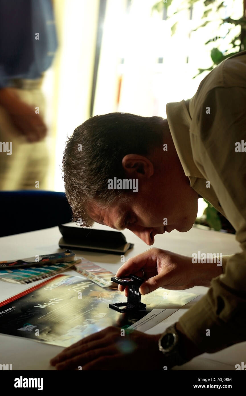 man looking through eye glass Stock Photo - Alamy
