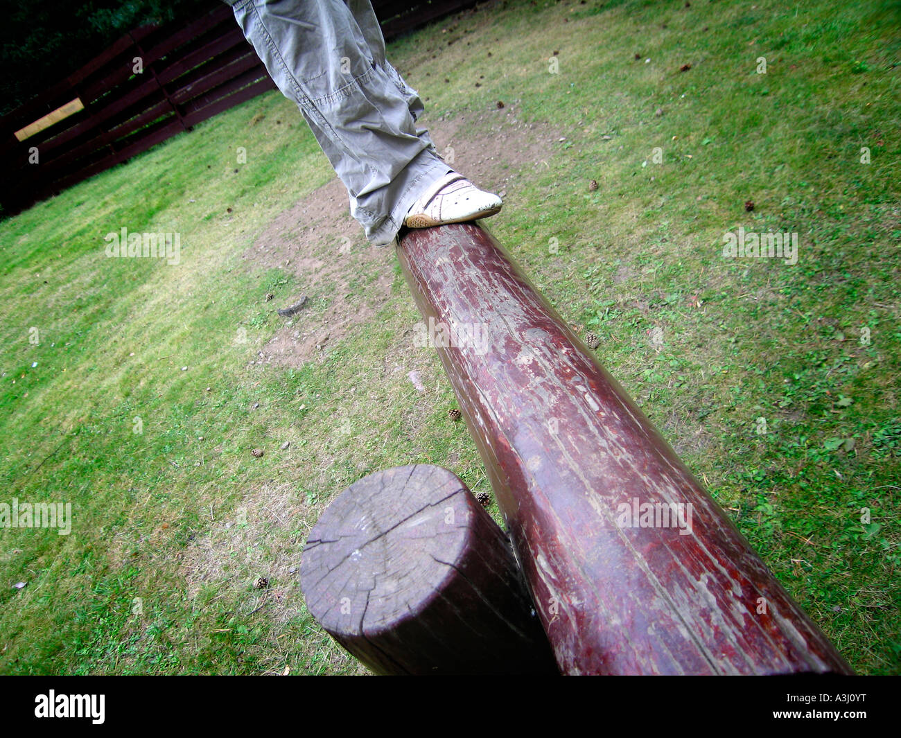 Young girl balancing on beam in playground Stock Photo - Alamy