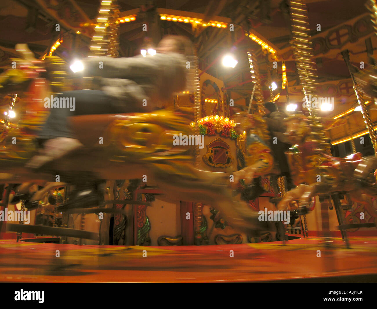 Traditional hobby horse merry go round fairground ride Stock Photo - Alamy