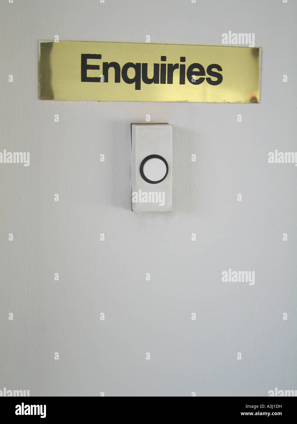 Enquiries bell call button on office wall Stock Photo - Alamy