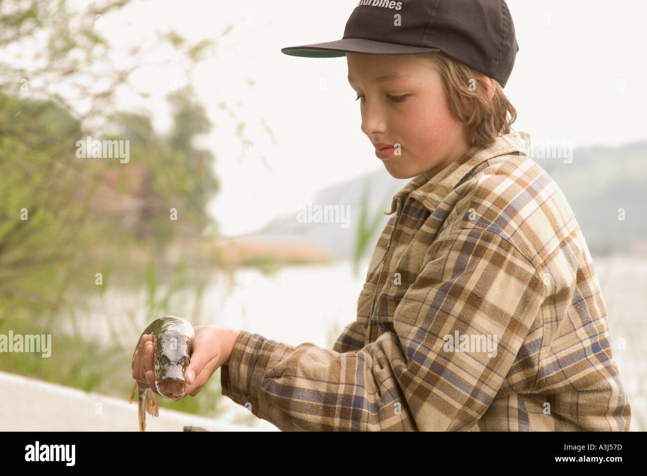 MR 10 years old boy shows proudly a pickerel Stock Photo - Alamy