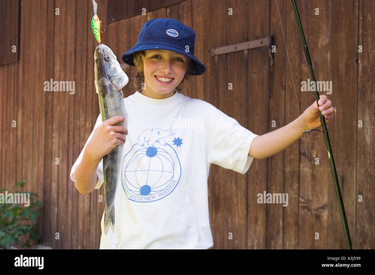 MR 10 years old boy shows proudly a zander Stock Photo - Alamy