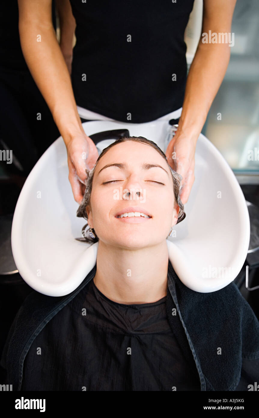 Woman having hair washed Stock Photo - Alamy