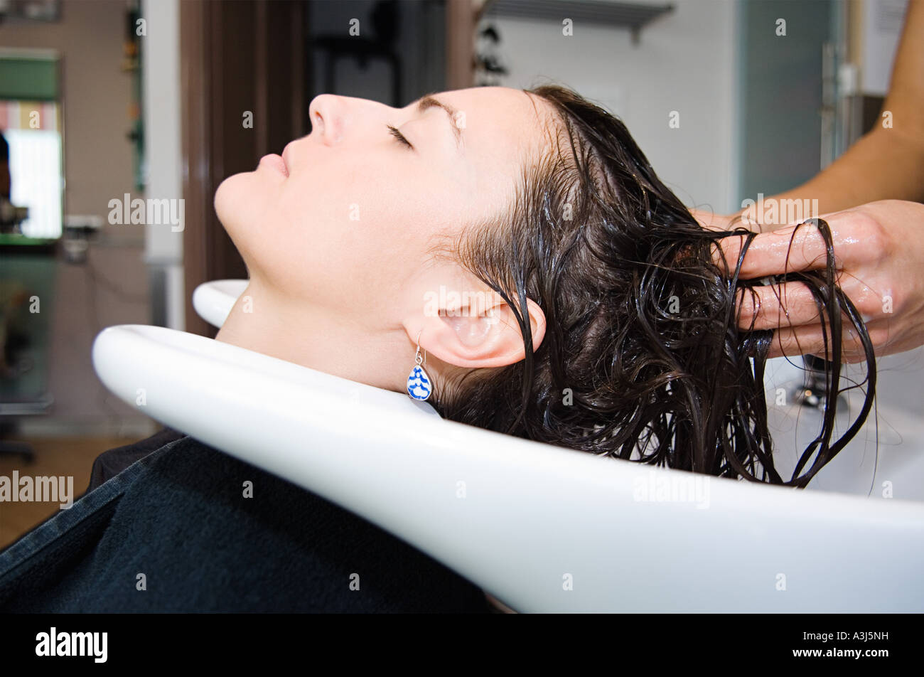 Woman having hair washed Stock Photo - Alamy
