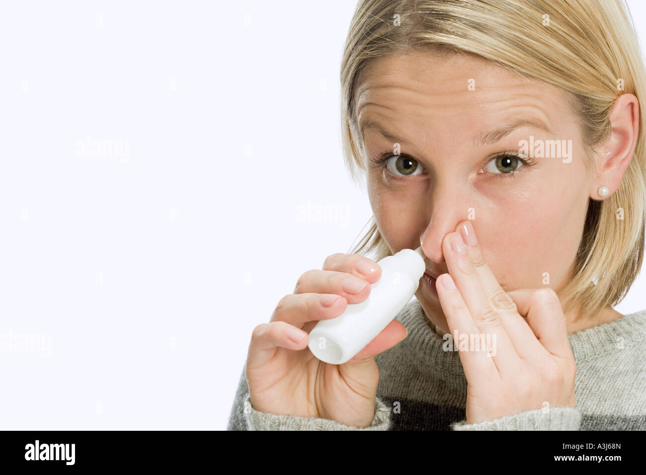 Woman inhaling nasal spray Stock Photo - Alamy