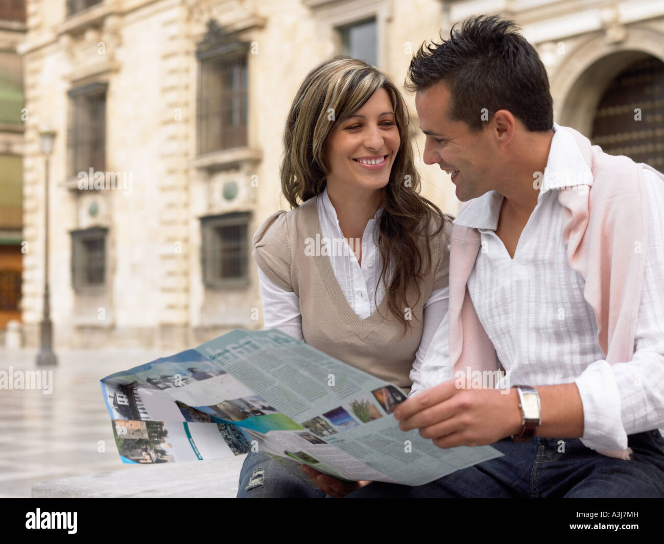 Couple with a map Stock Photo - Alamy