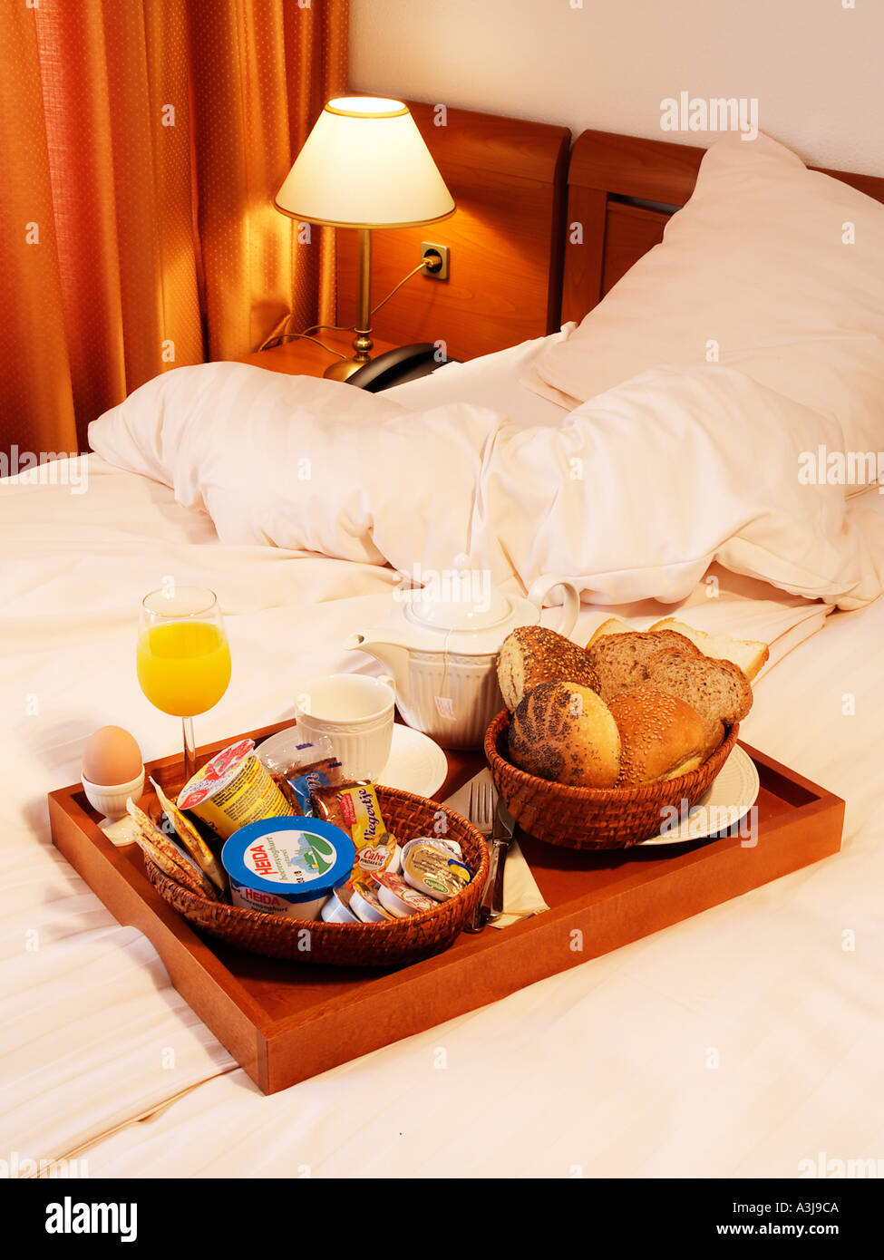 Hotel breakfast on a tray on a typical average hotelbed Stock Photo - Alamy