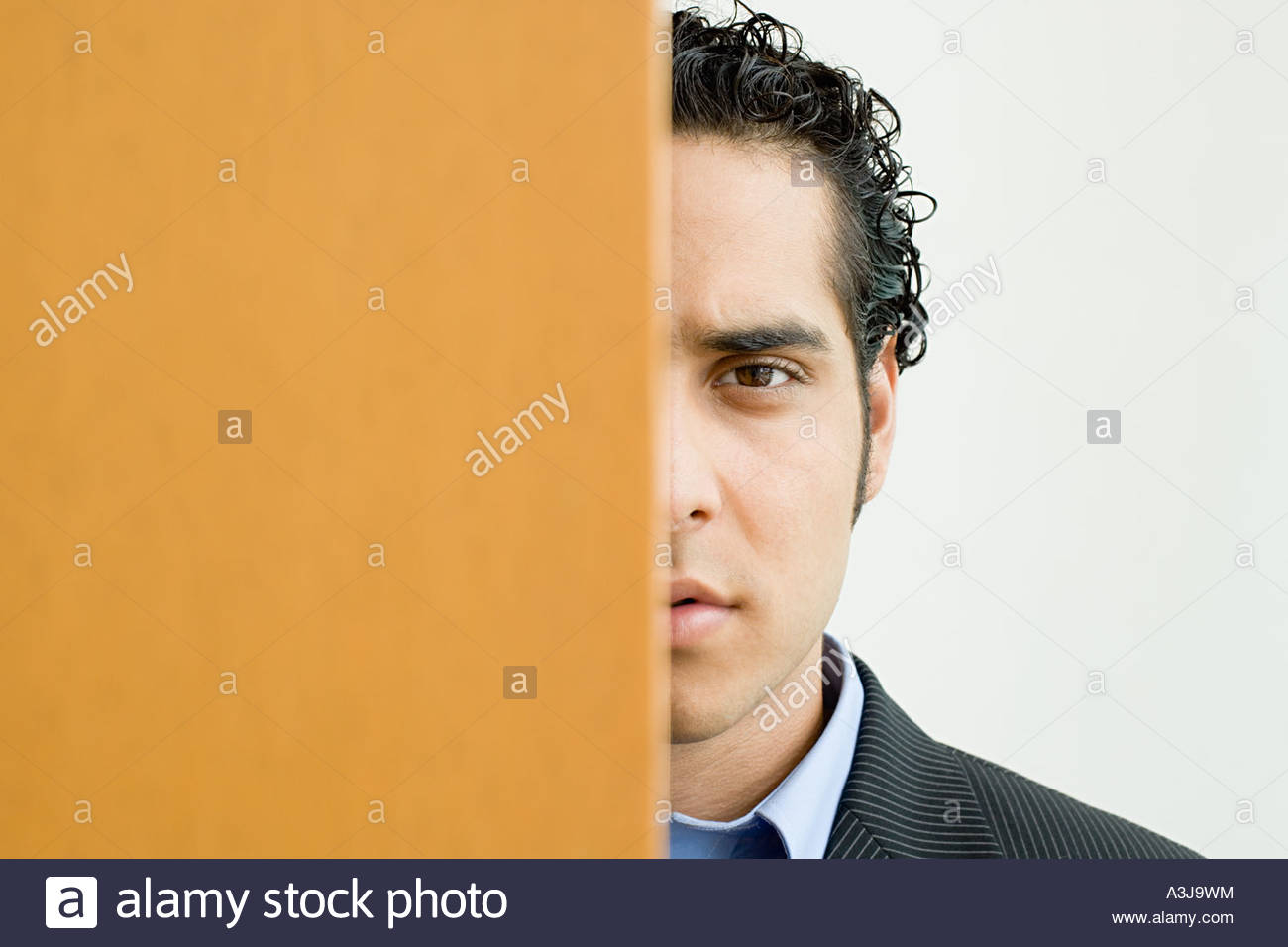 Young Man Hiding Behind Office Stock Photos & Young Man Hiding Behind ...