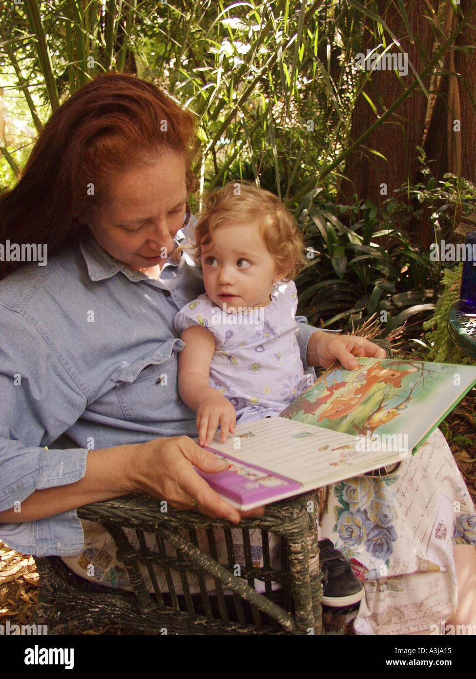 Mother reading to a infant child Stock Photo - Alamy