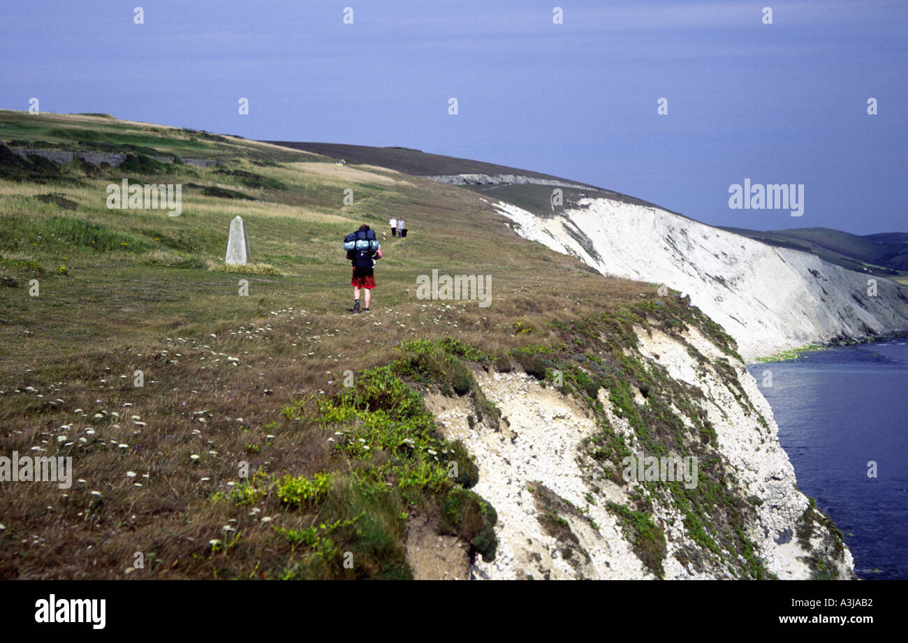 Walkers on the Coastal path on Afton Down looking at Compton Bay and ...