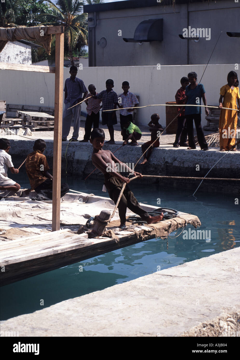Maldivian boy pulling a rope Stock Photo - Alamy