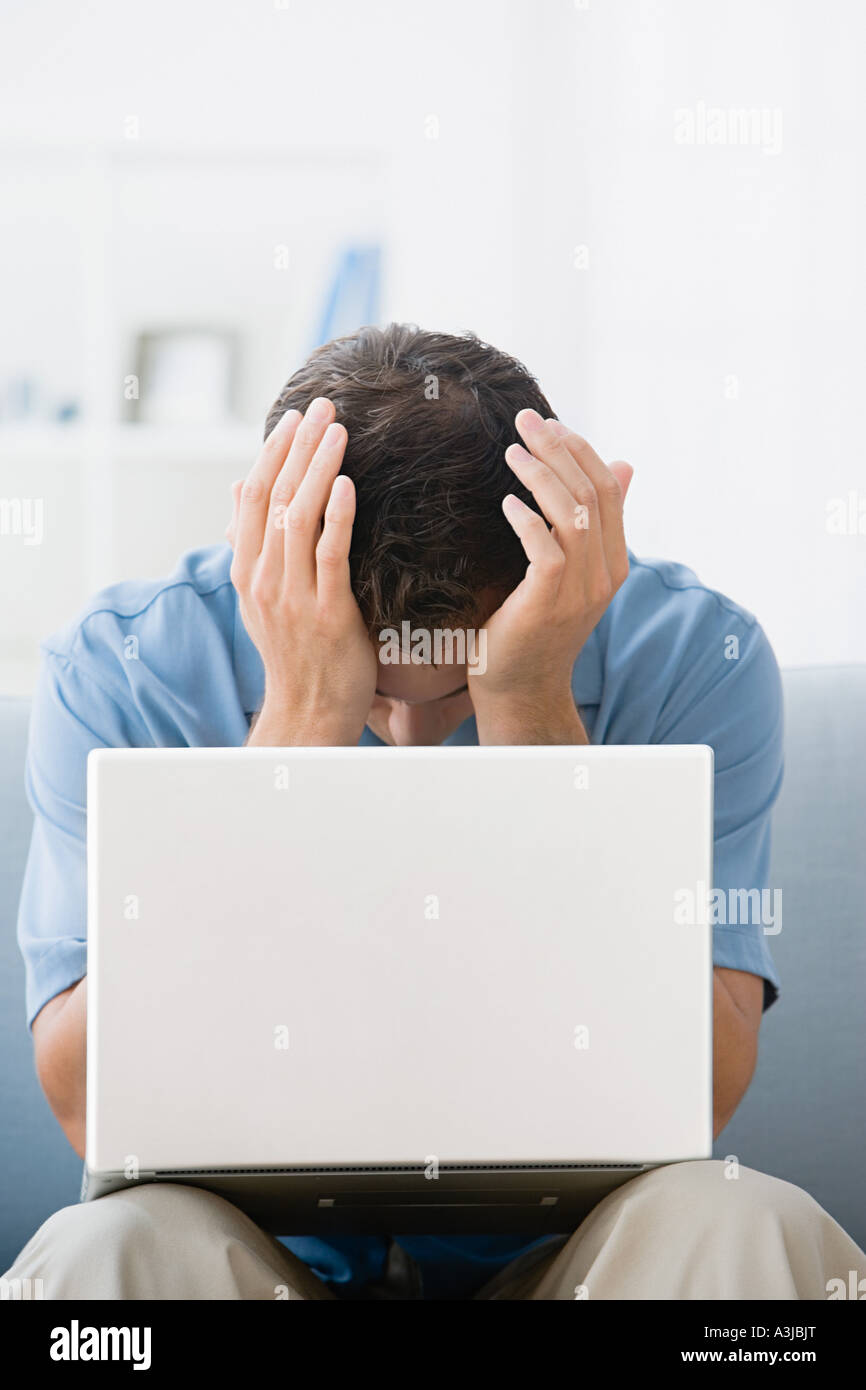 Man with his head in hands Stock Photo - Alamy
