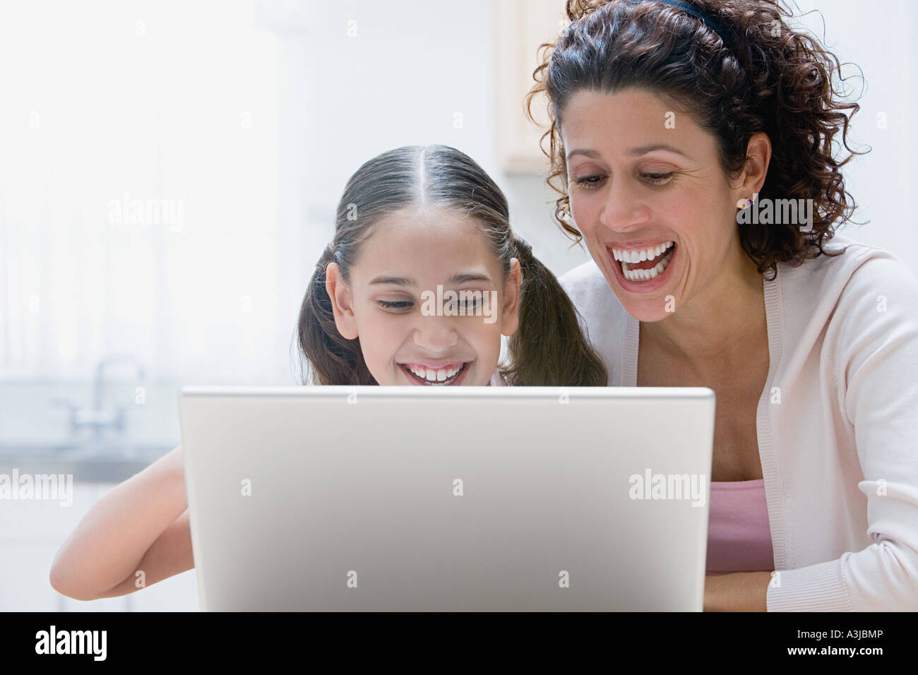 Mother and daughter using a laptop computer Stock Photo - Alamy