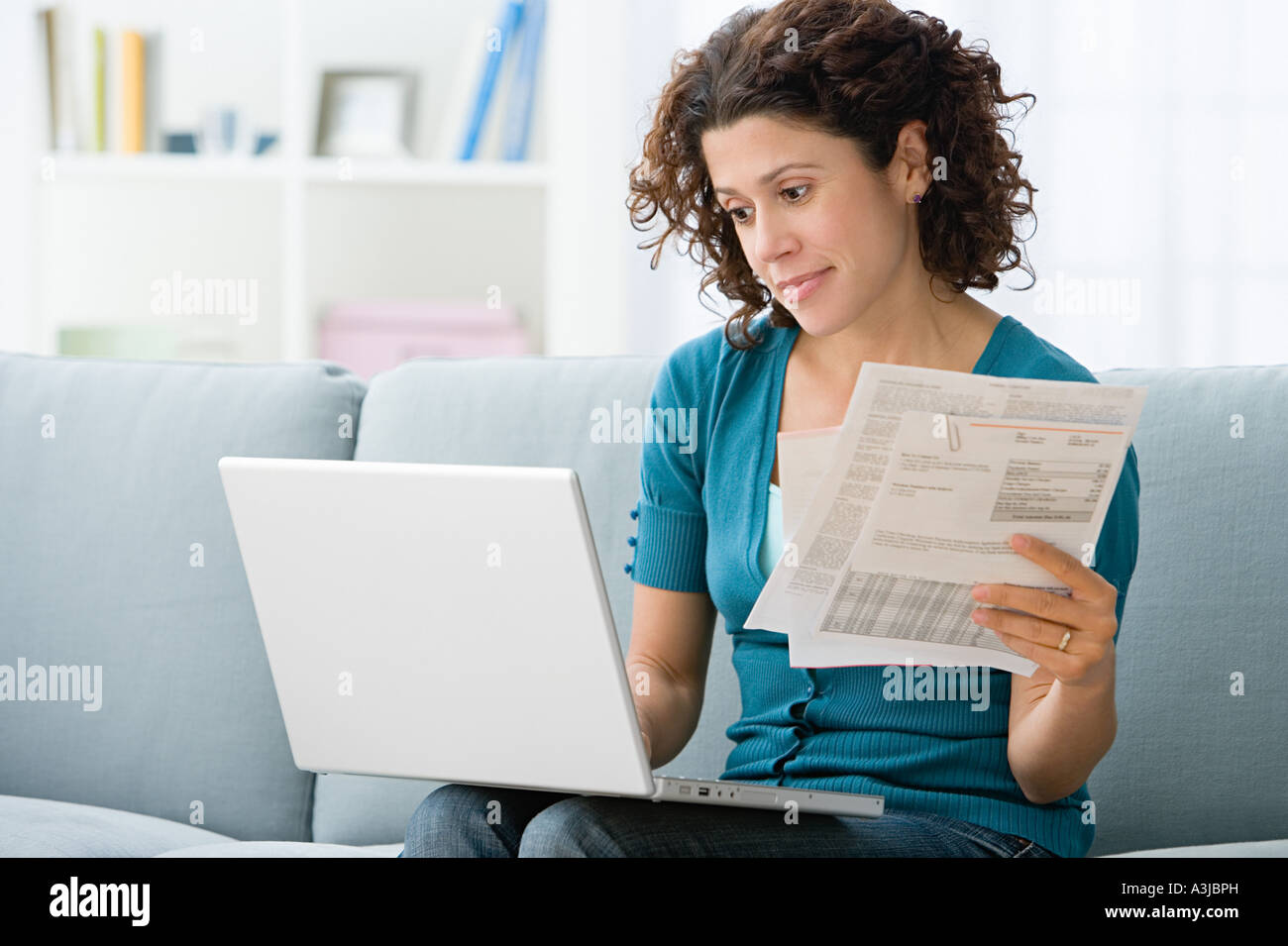 Woman paying bills online Stock Photo - Alamy