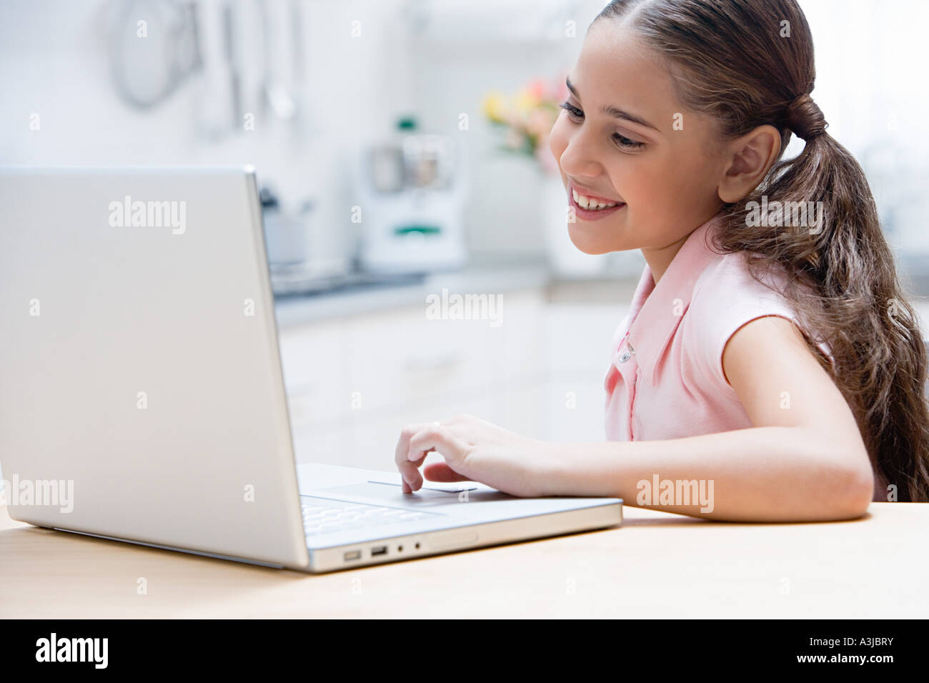 Girl using a laptop computer Stock Photo - Alamy