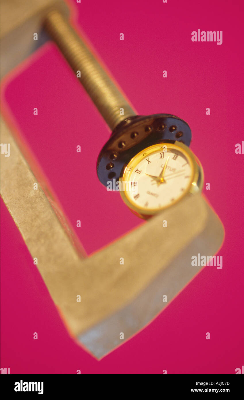 Watch in Clamp Squeezing Time Stock Photo - Alamy