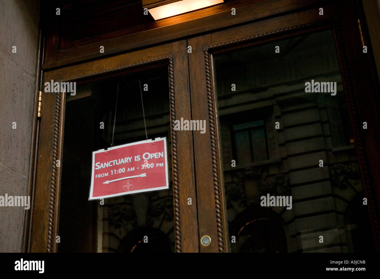 Wooden door with sign saying SANCTUARY IS OPEN Stock Photo - Alamy