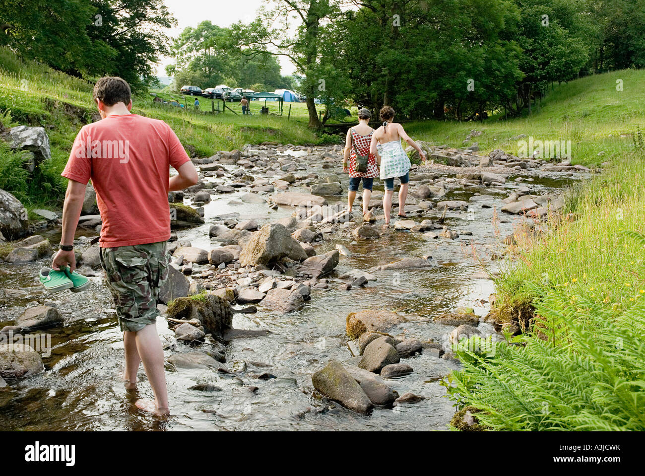People walking in stream Stock Photo - Alamy