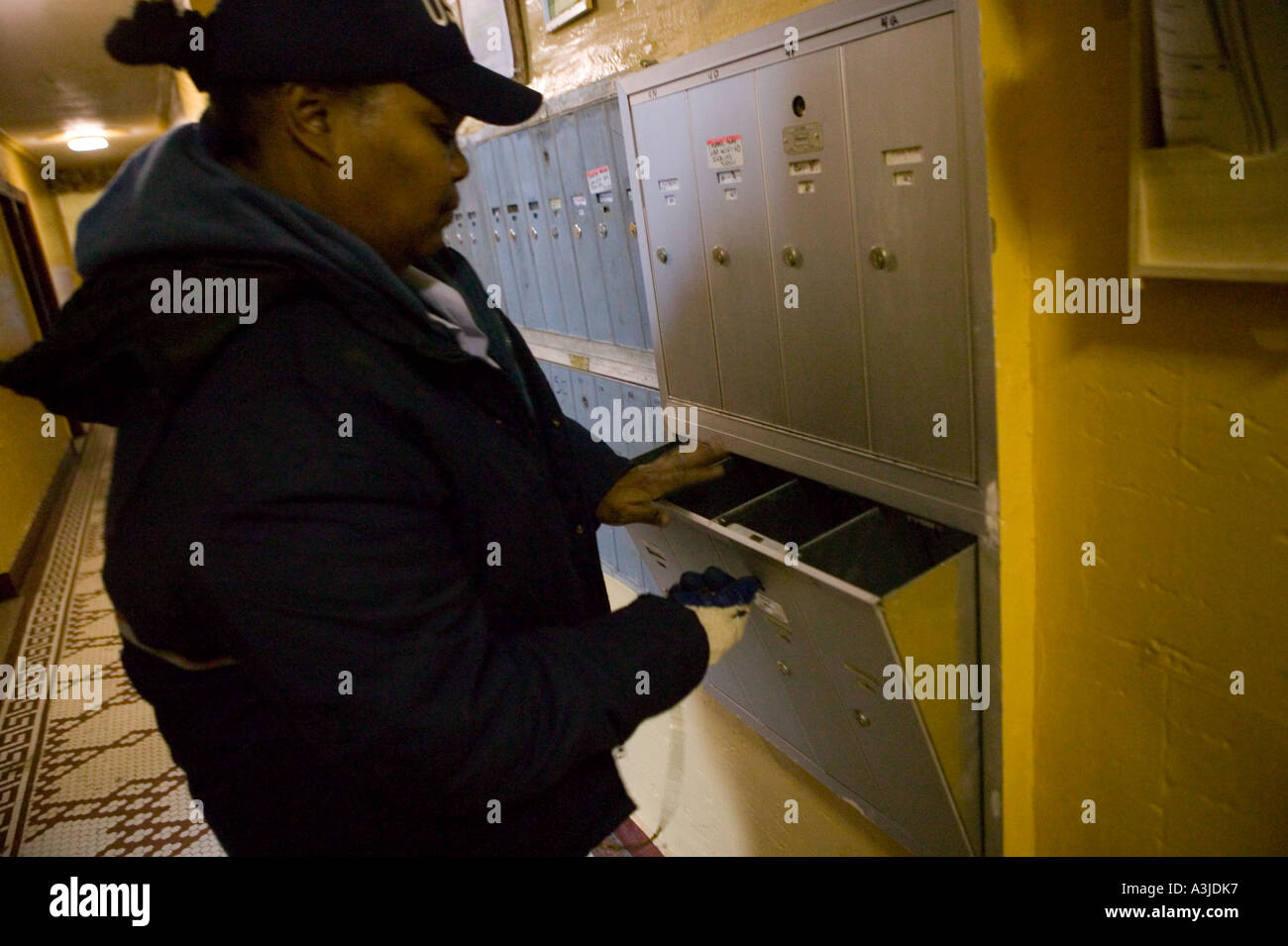 A United States Postal Service delivers mail to an apartment building ...