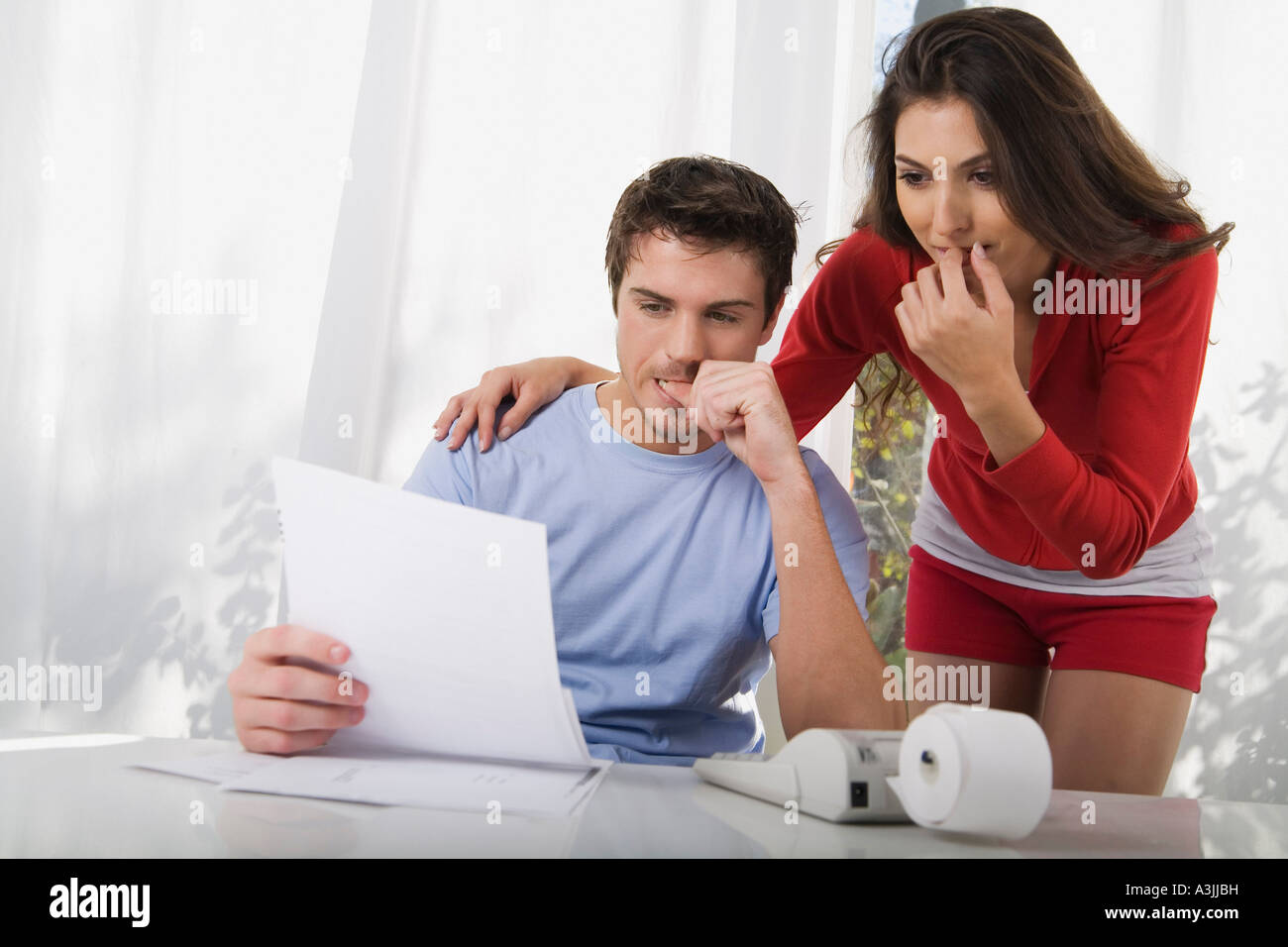 Couple Looking at Document Stock Photo - Alamy