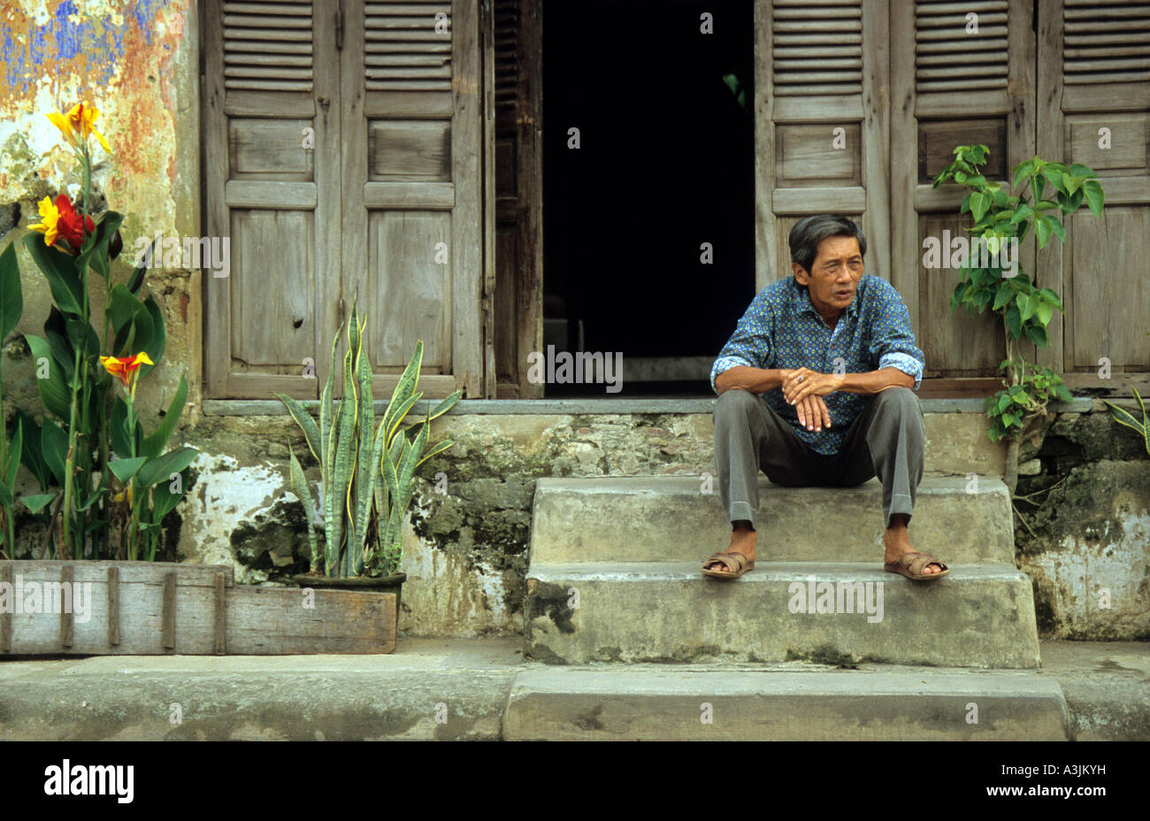 Man outside his house in Hoi An Stock Photo - Alamy