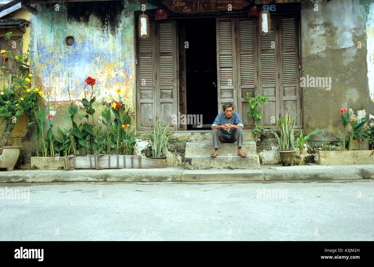 Man outside his house in Hoi An Stock Photo - Alamy