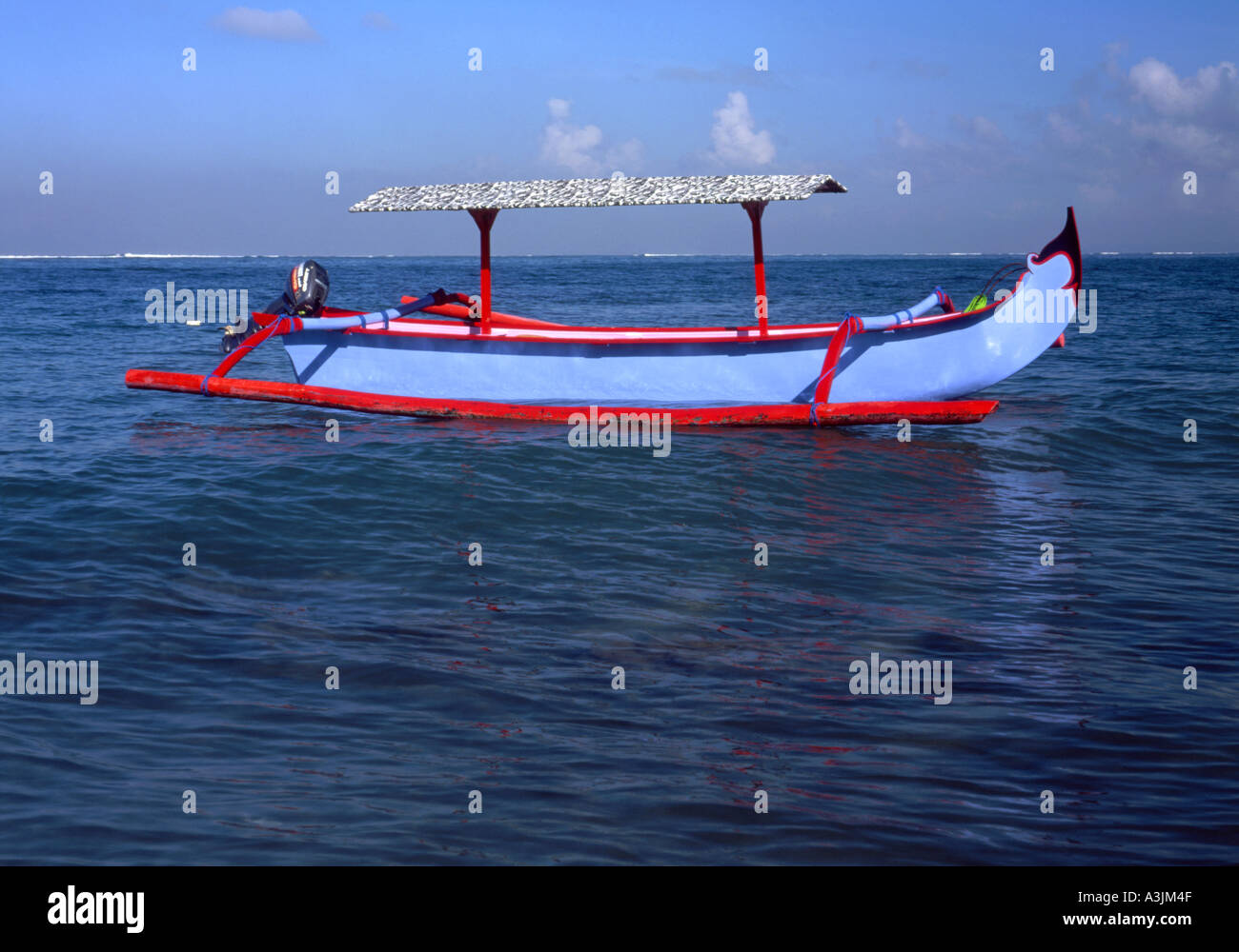 Traditional Balinese fishing boat used for tourists at anchored in a ...