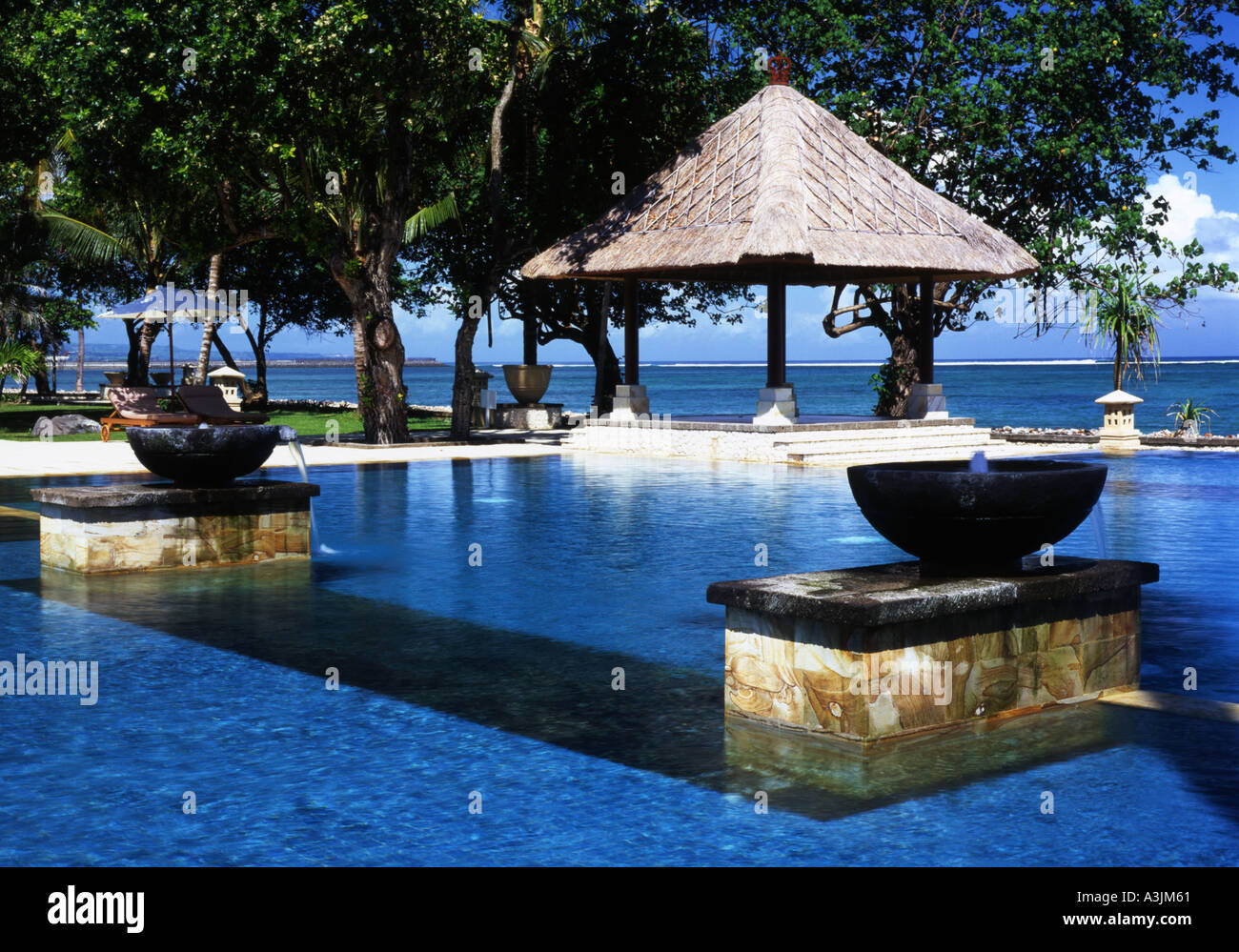 Beautiful blue swimming pool at the luxurious beach front Putra Bali ...